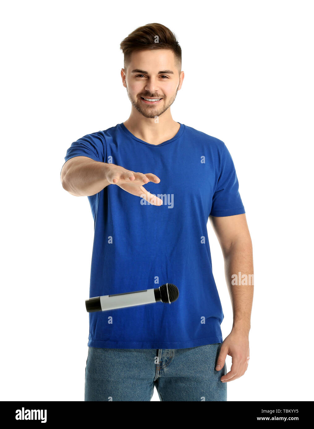 Handsome man dropping microphone on white background Stock Photo - Alamy
