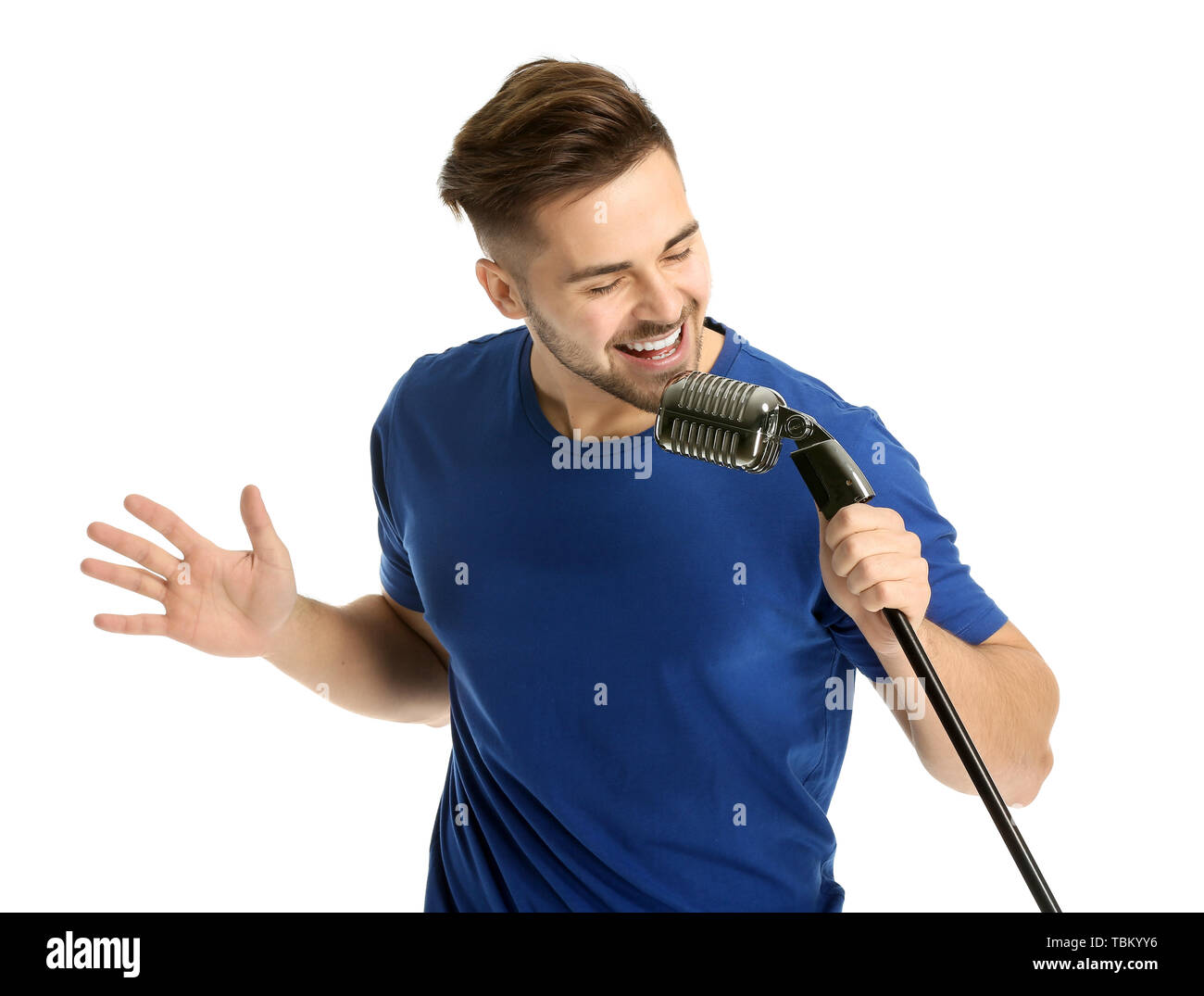 Handsome male singer with microphone on white background Stock Photo ...