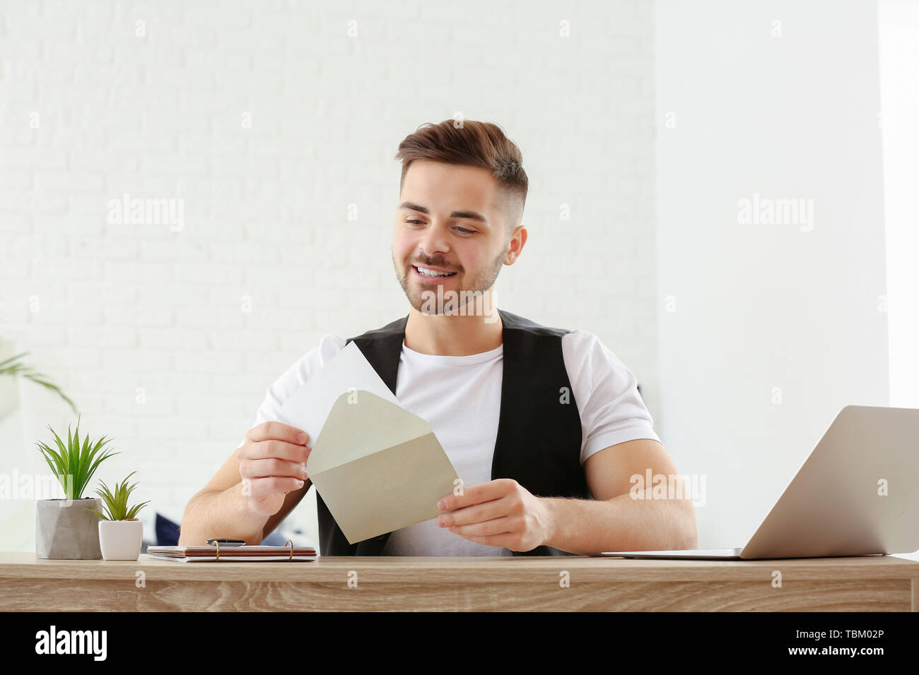 Man opening envelope hi-res stock photography and images - Alamy