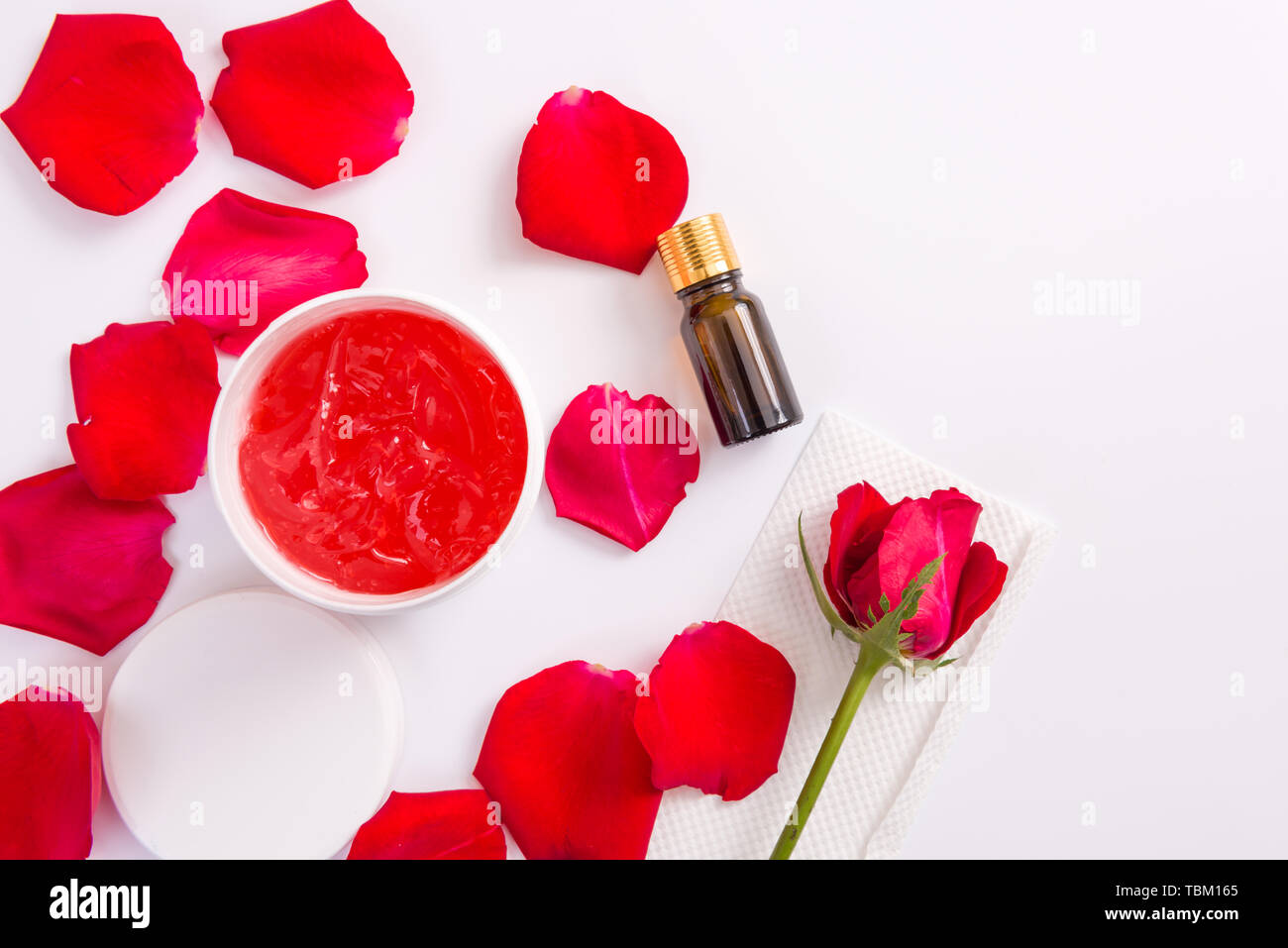 Red rose petals and refined skin care products Stock Photo - Alamy