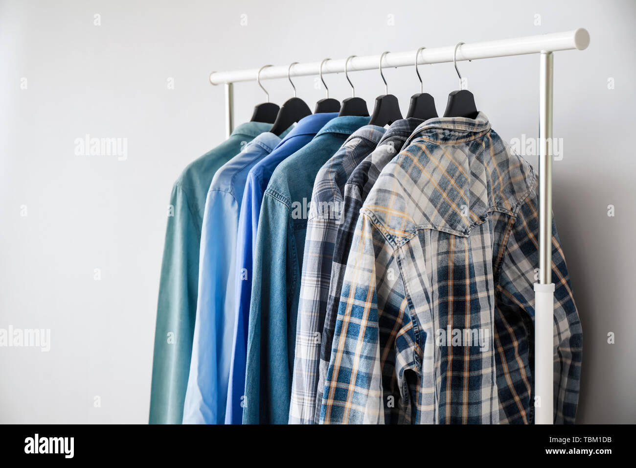 Rack with stylish clothes on grey background Stock Photo - Alamy