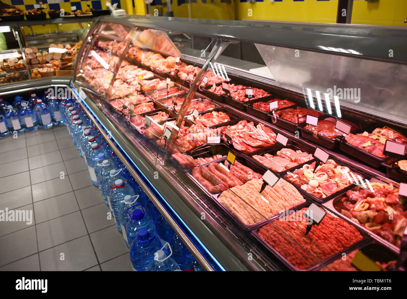 Refrigerated display case with fresh meat in supermarket Stock Photo ...