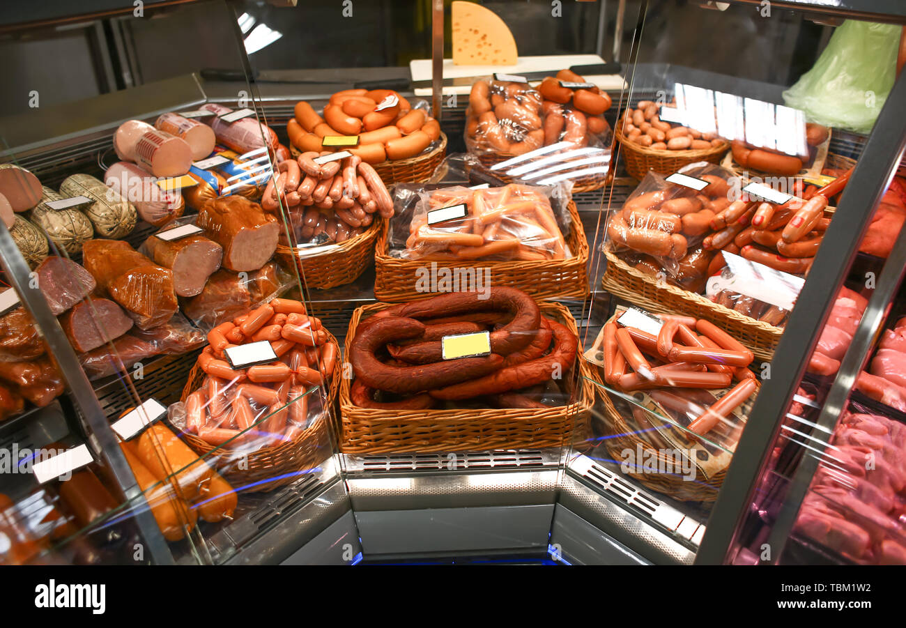 Refrigerated display case with fresh sausages in supermarket Stock ...