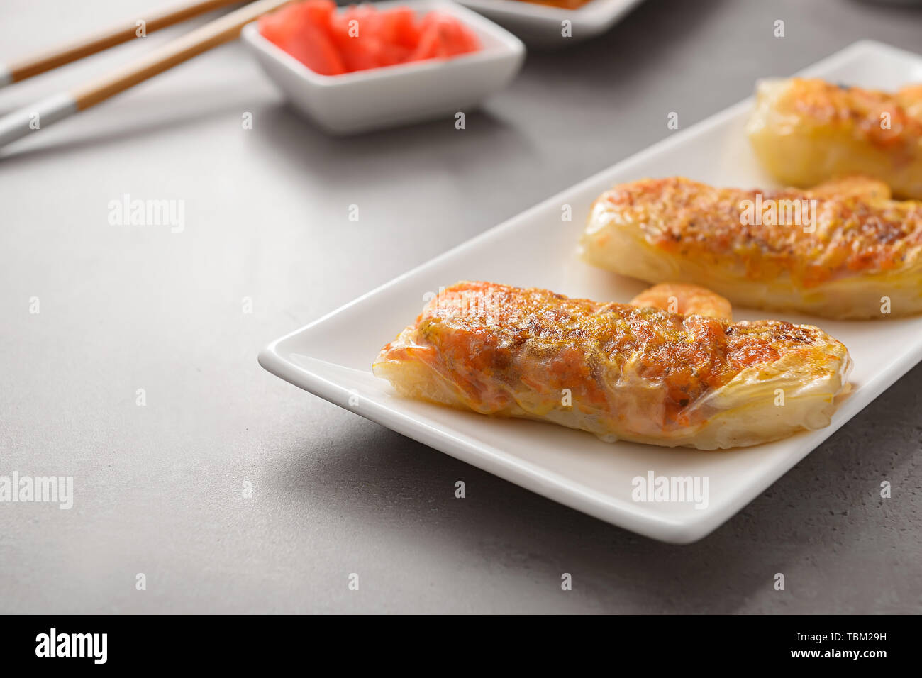 Plate with tasty fried spring rolls on table Stock Photo - Alamy