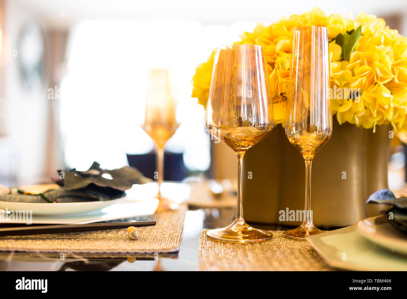 elegant crockery on dining table in modern dining room Stock Photo - Alamy