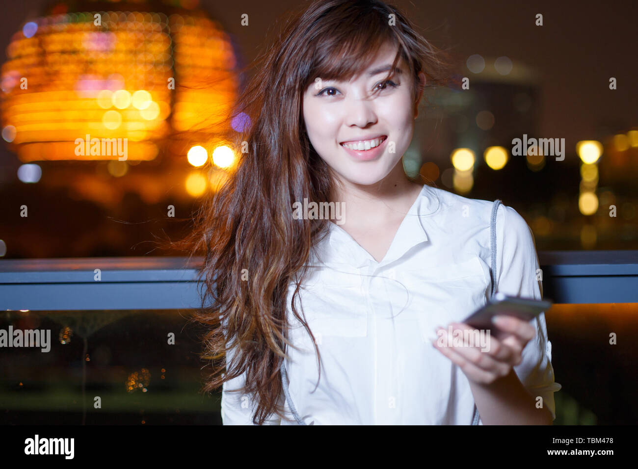beautiful asian girl using mobile phone at night Stock Photo - Alamy