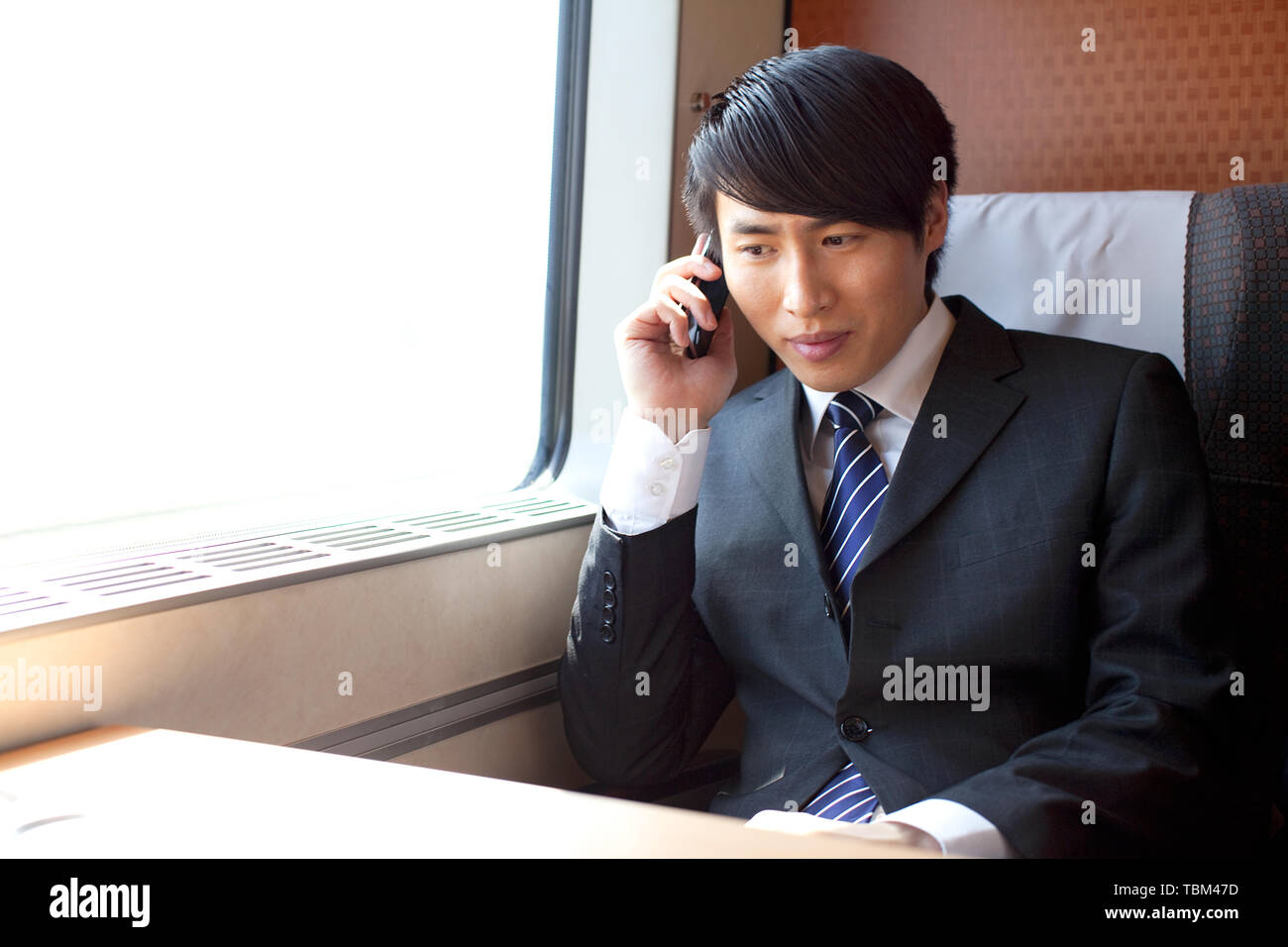 A business person on a train Stock Photo - Alamy