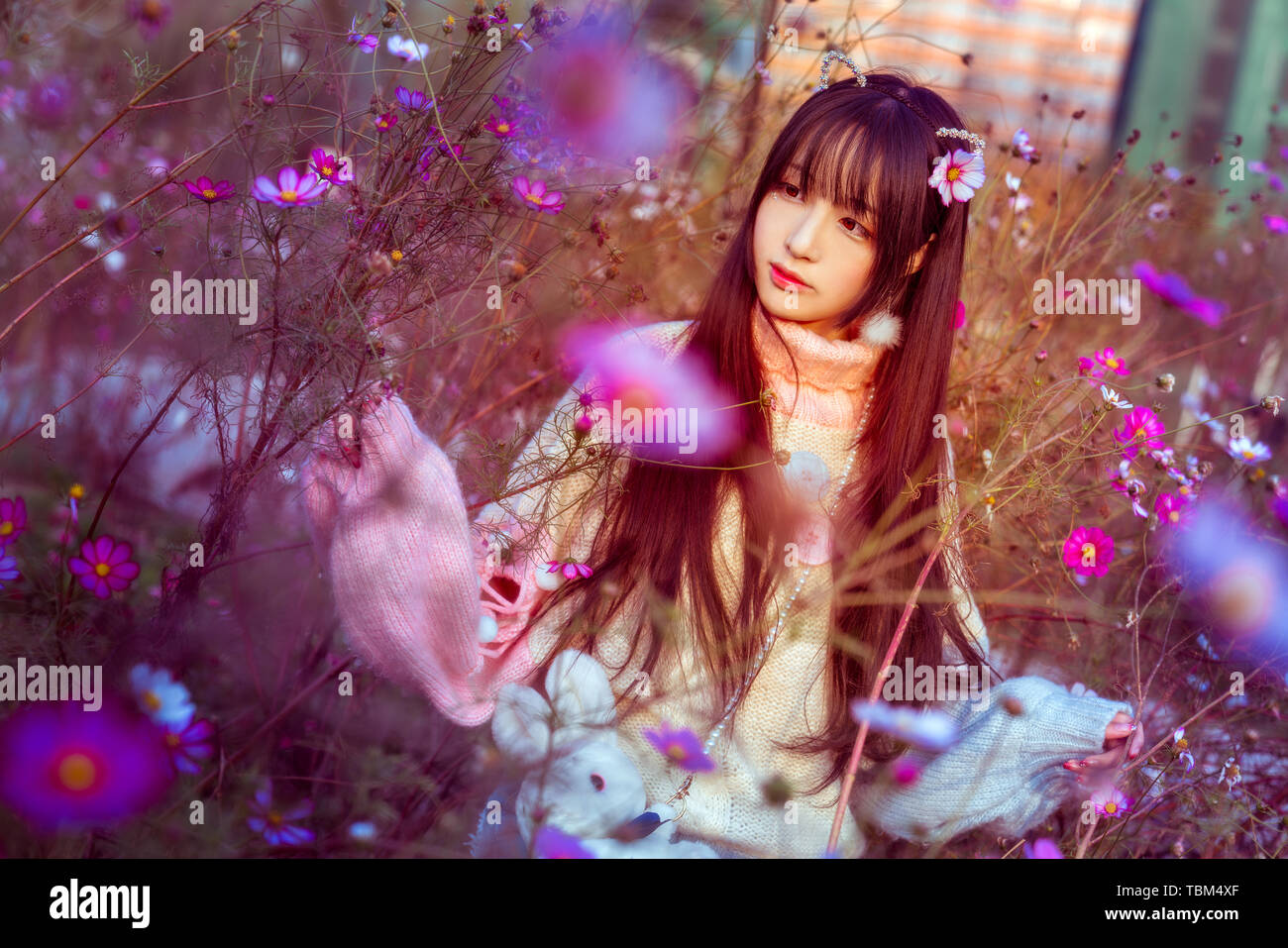 A girl surrounded by flowers Stock Photo - Alamy