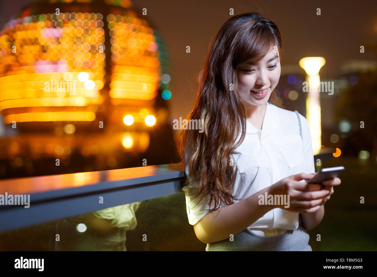 Asian girl using mobile phone hi-res stock photography and images - Alamy