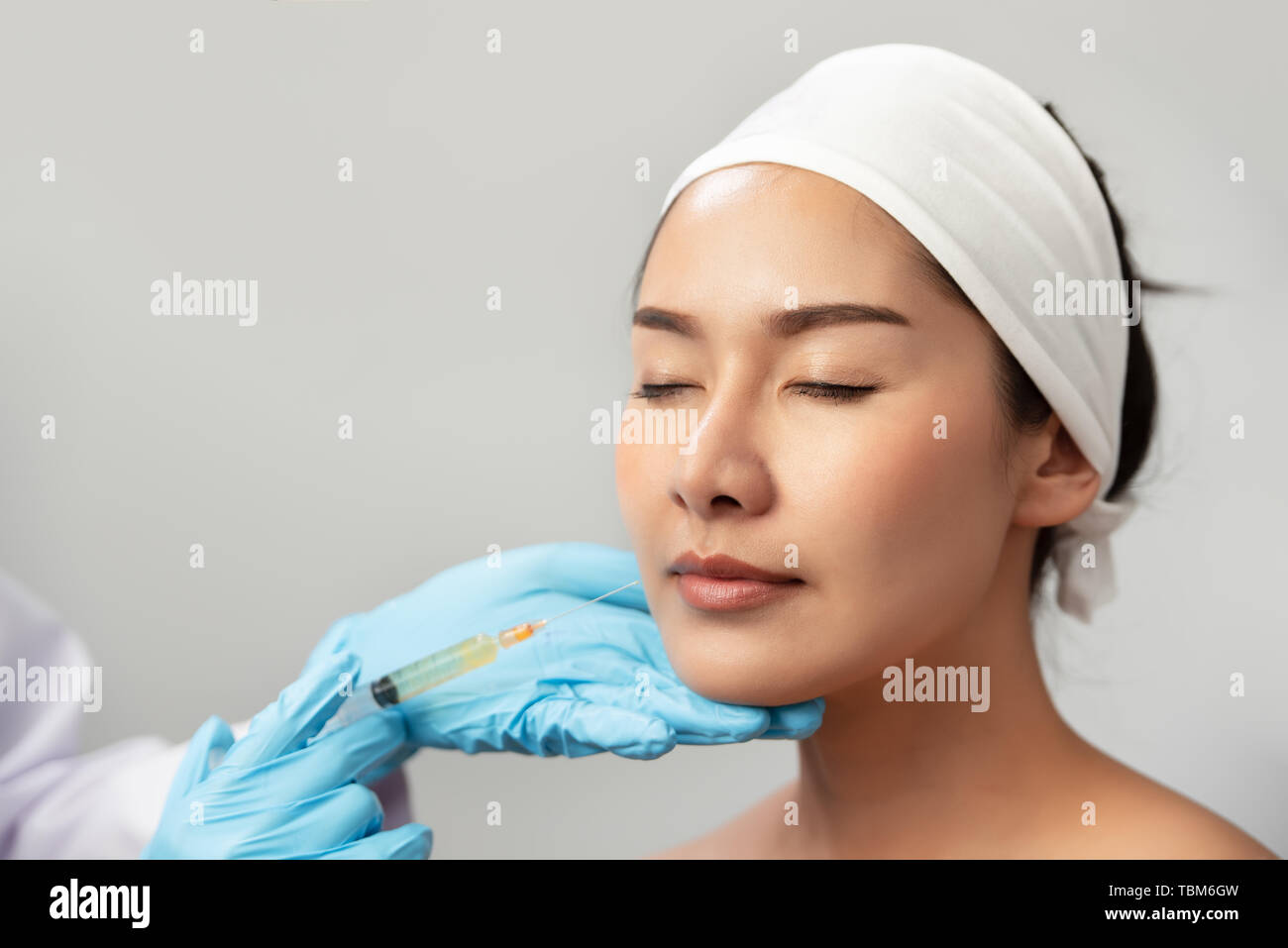 Cheek filler injection treatment injection. Woman face plastic surgery ...