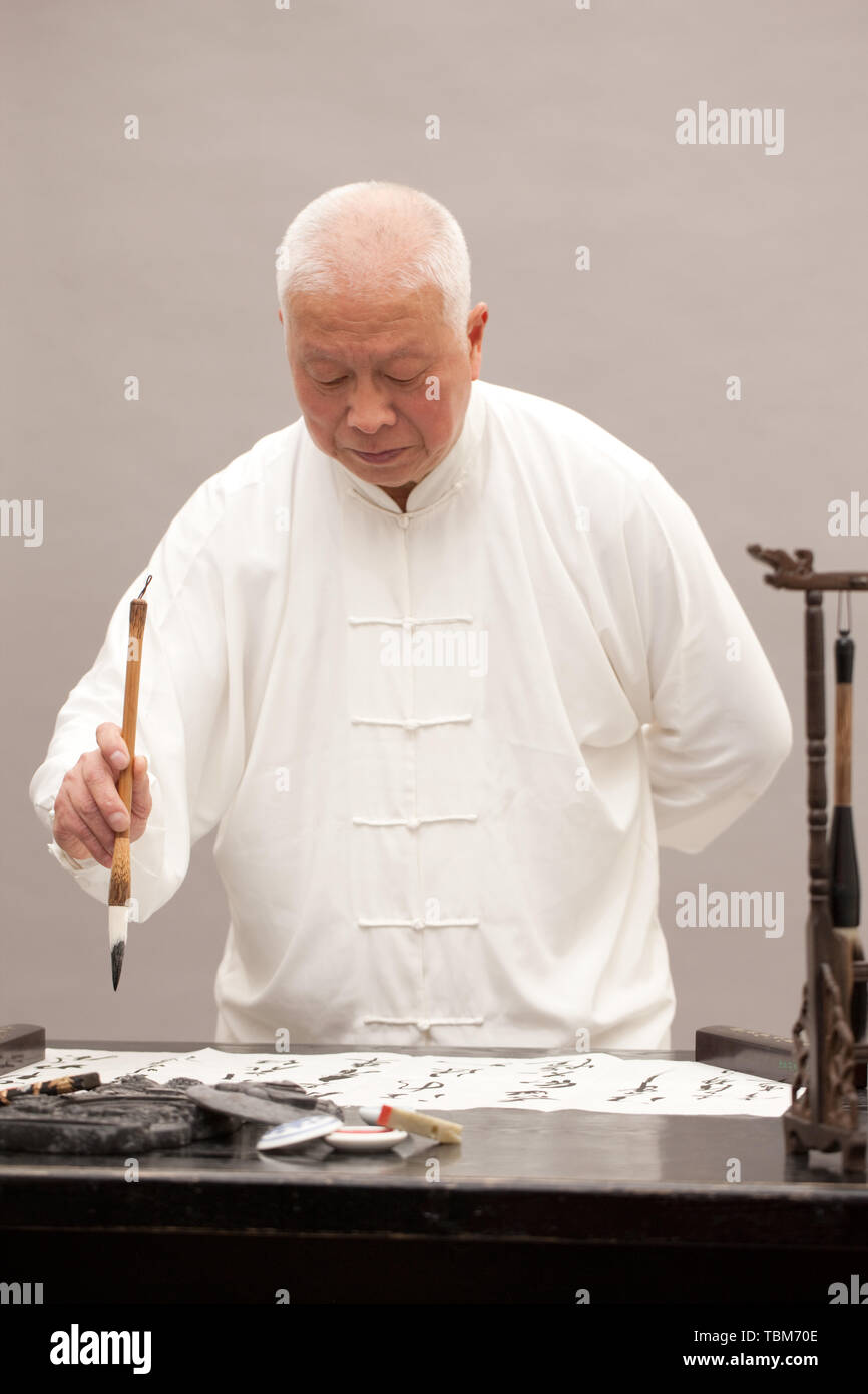 An old man practicing calligraphy Stock Photo - Alamy