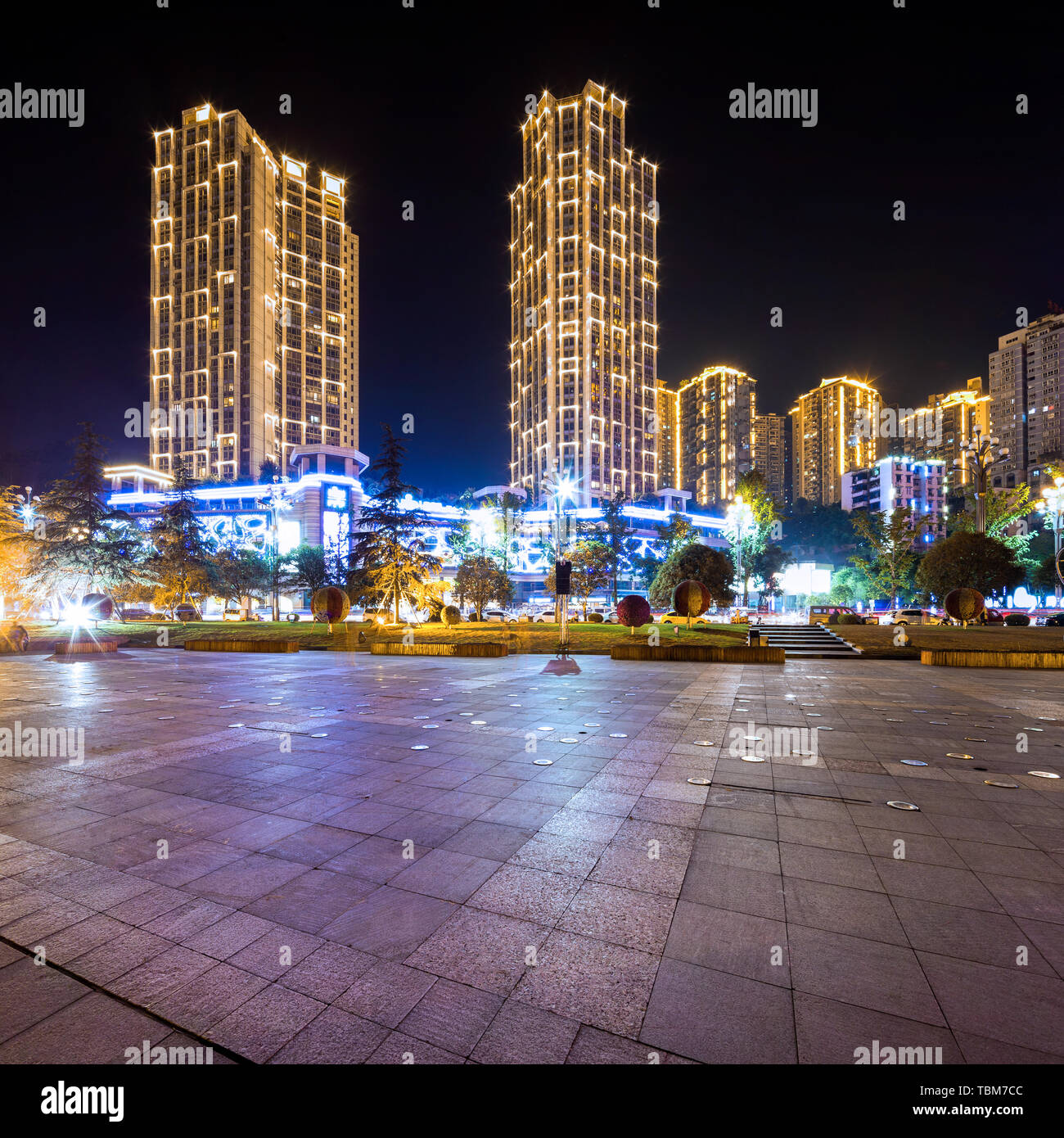 Empty floor and illuminated skyscraper Stock Photo - Alamy