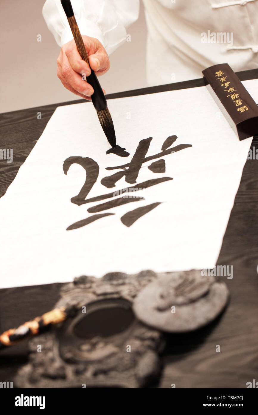 An old man practicing calligraphy Stock Photo - Alamy