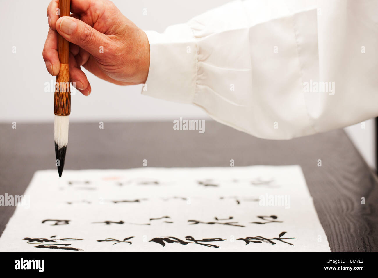 An old man practicing calligraphy Stock Photo - Alamy