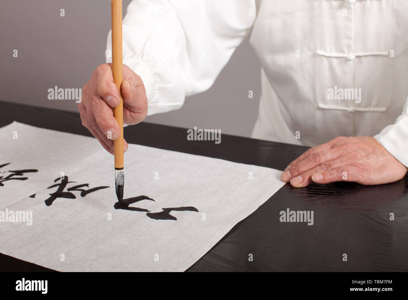 An old man practicing calligraphy Stock Photo - Alamy