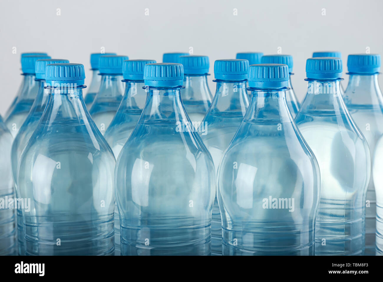 Bottles of water on light background Stock Photo - Alamy