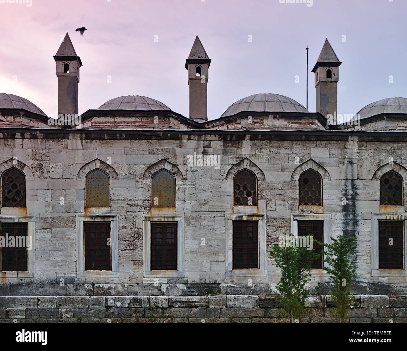 Blue mosque exterior wall, with domes and chimneys, dusk time, Istanbul ...
