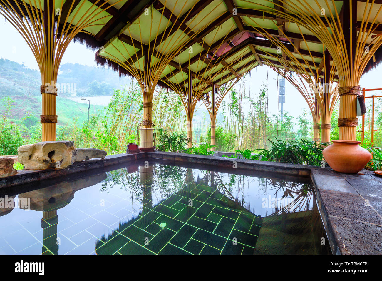 outdoor spa pool with bamboo shelf Stock Photo - Alamy