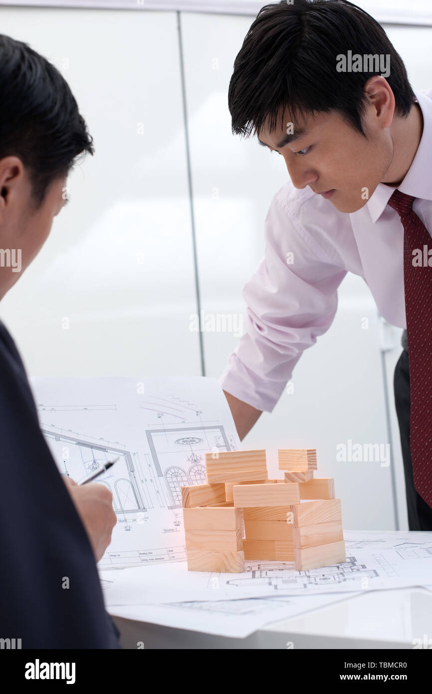 Business people analyzing drawings Stock Photo - Alamy