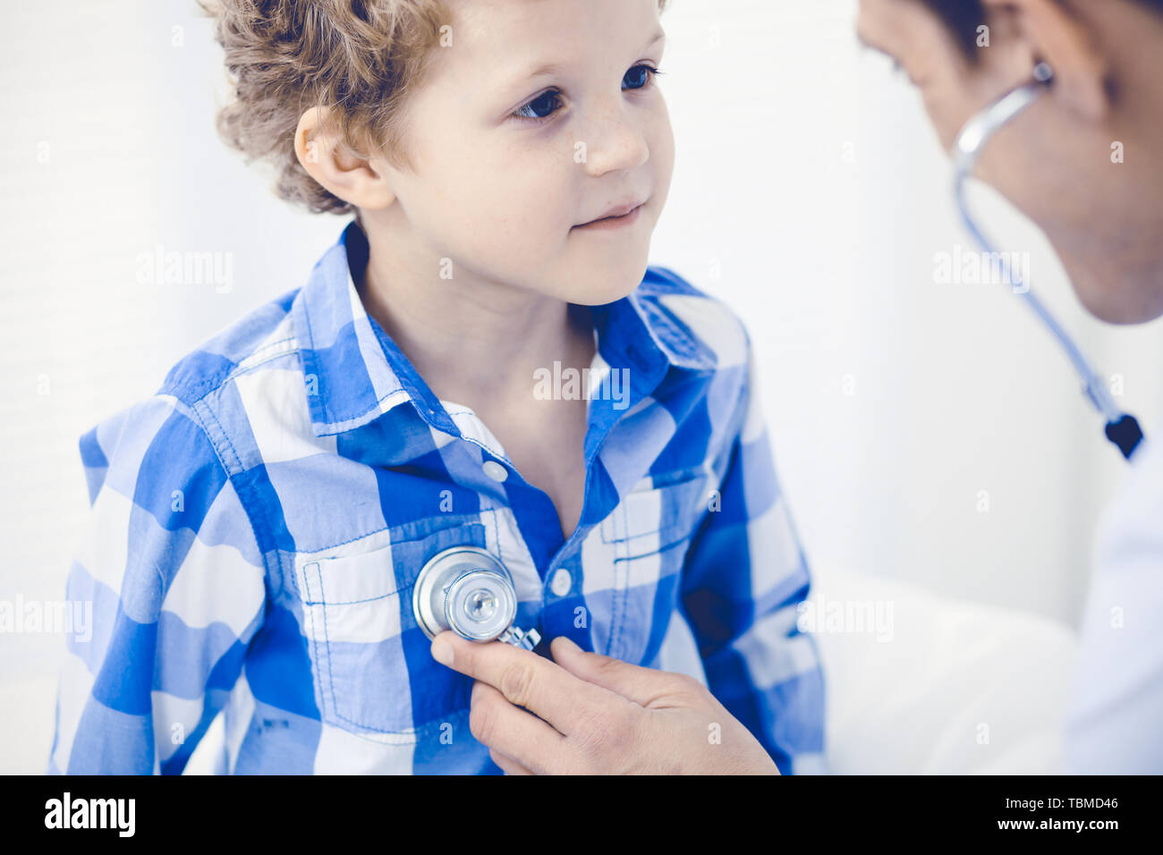 Doctor and patient child. Physician examining little boy. Regular ...