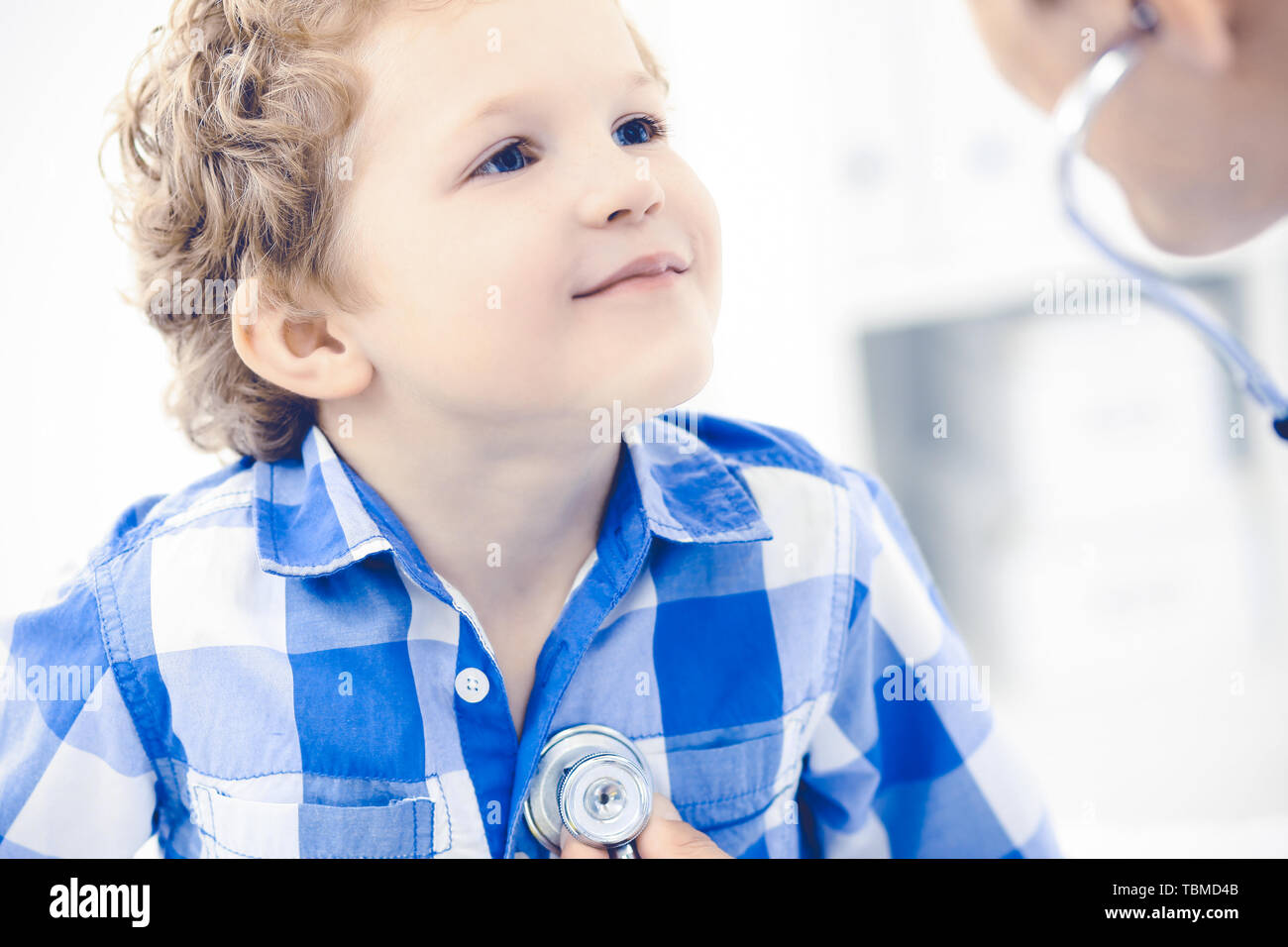 Doctor and patient child. Physician examining little boy. Regular ...