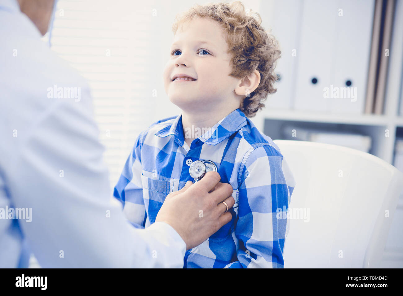Doctor and patient child. Physician examining little boy. Regular ...
