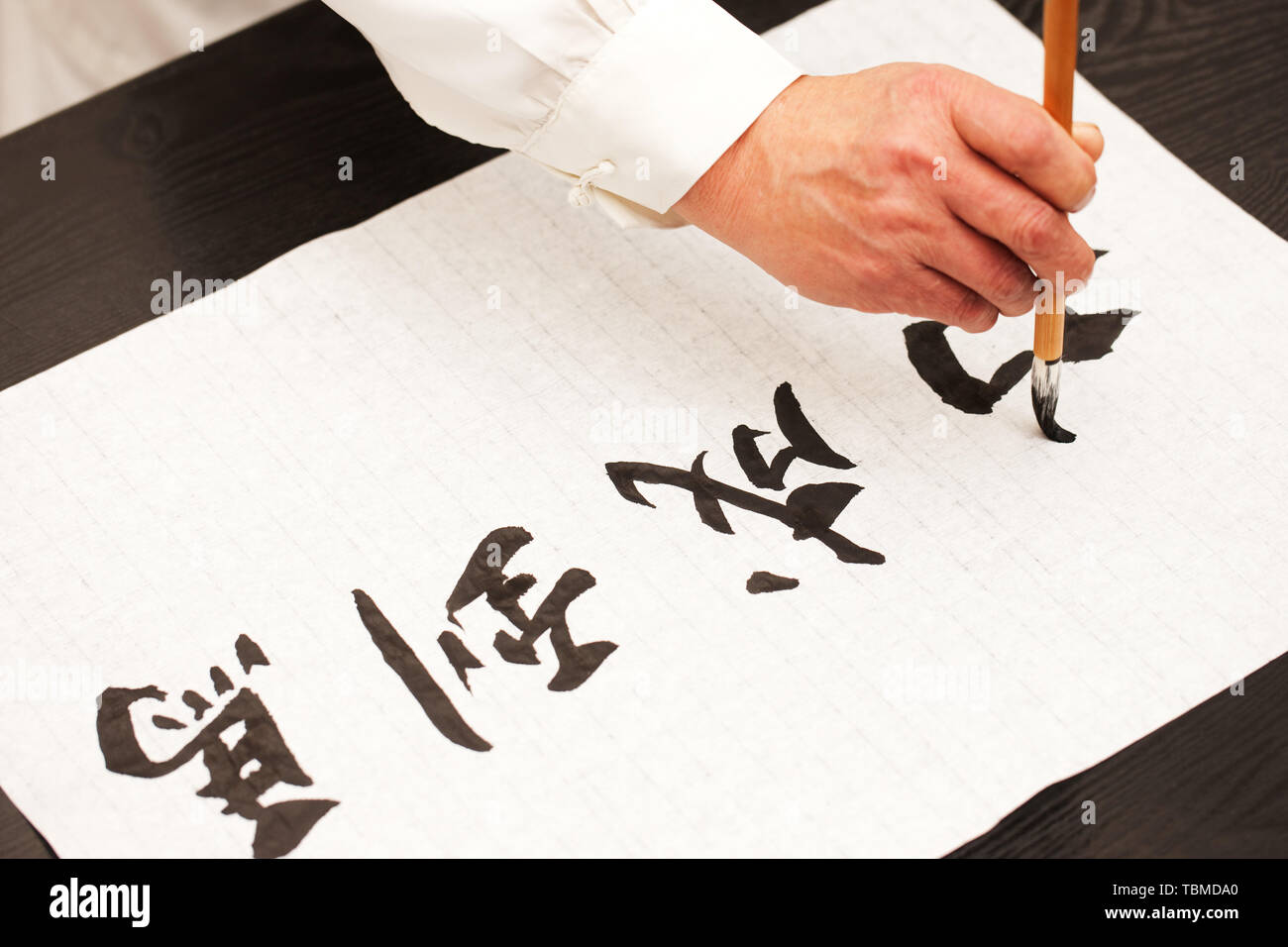 An old man practicing calligraphy Stock Photo - Alamy