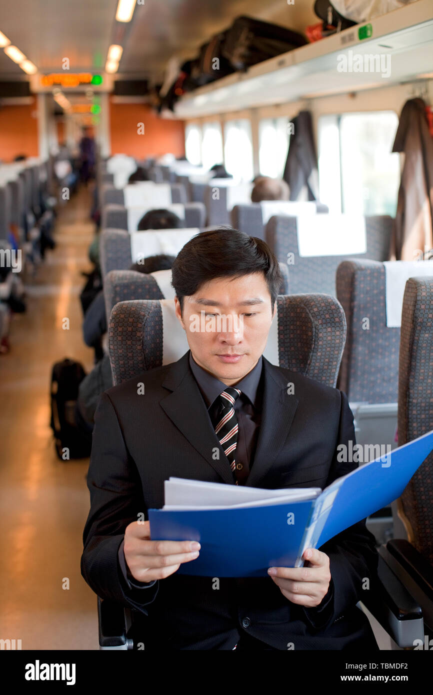 A business person on a train Stock Photo - Alamy
