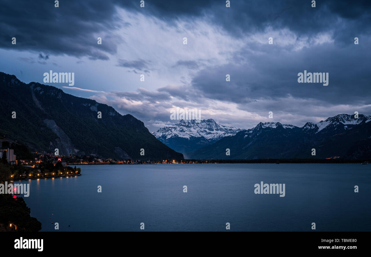 Evening lights in the towns on the banks of Lake Geneva in Switzerland ...