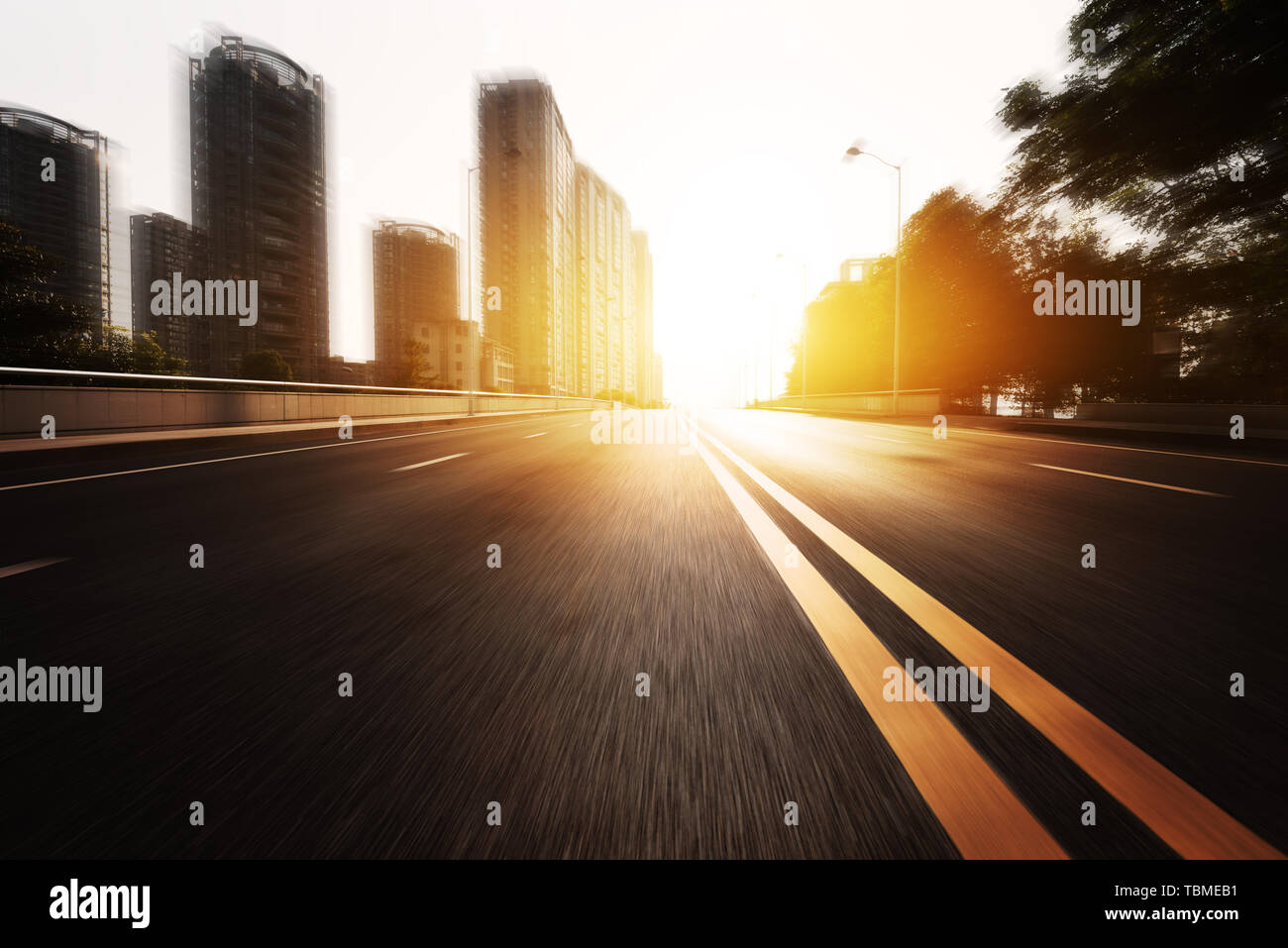 sunlight skyline and road by modern buildings Stock Photo - Alamy