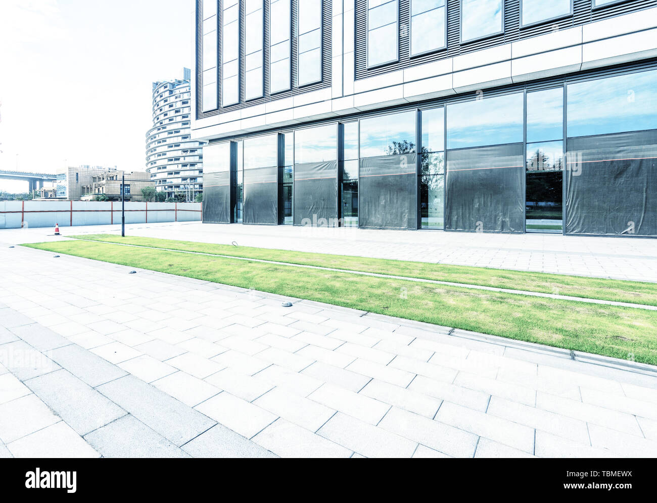 empty footpath front of modern building in blue sky Stock Photo - Alamy