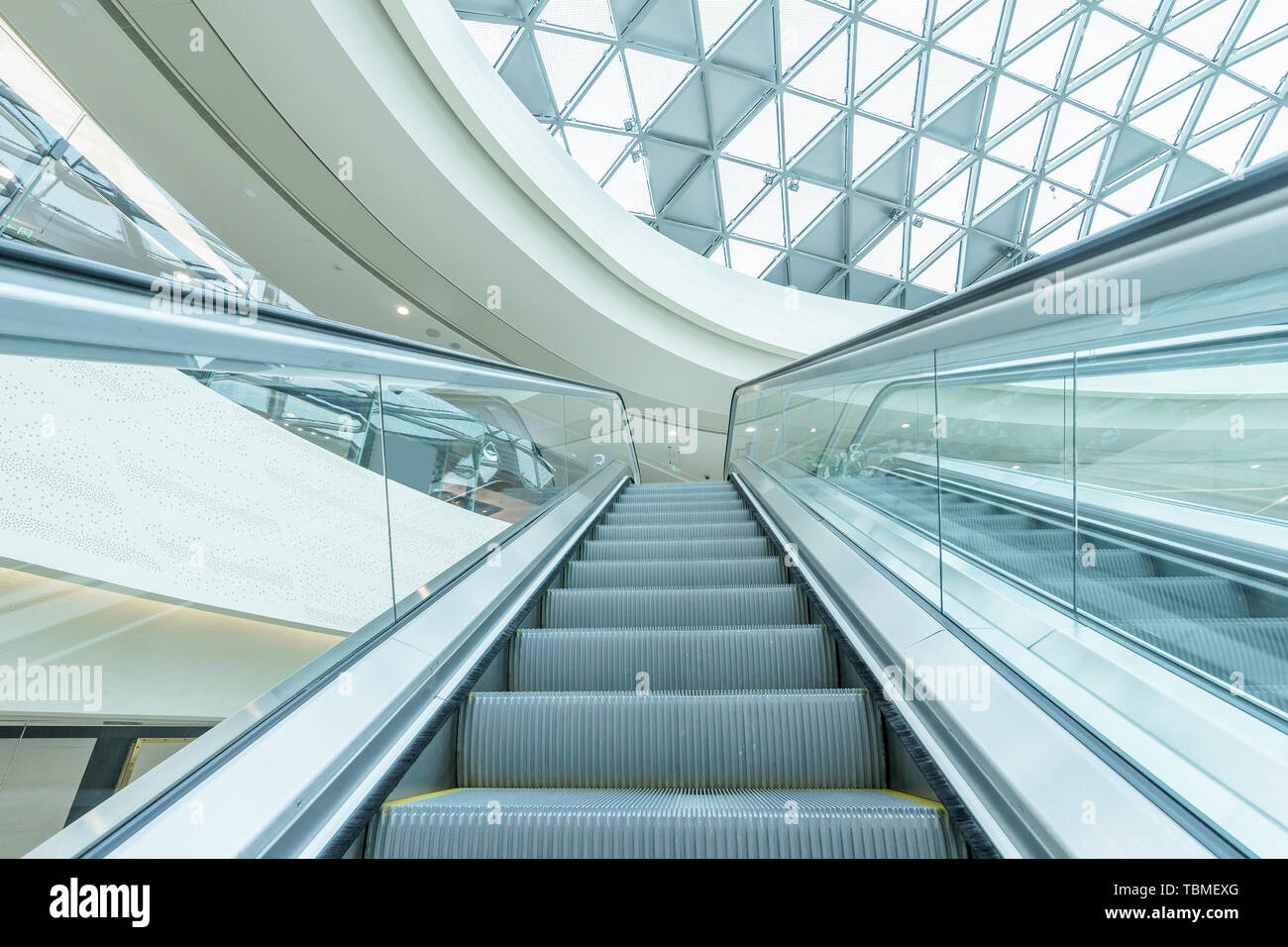 Automatic staircase in indoor shopping mall with ceiling hi-res stock ...