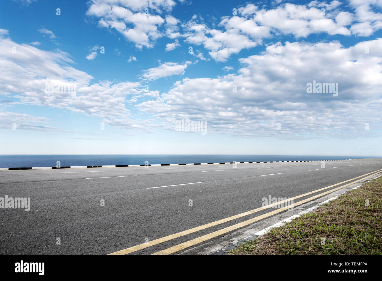 empty asphalt road with blue sea in blue sky Stock Photo - Alamy
