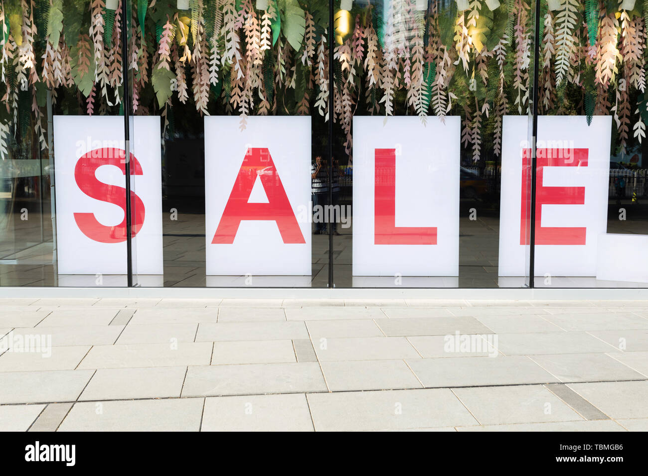 Sale poster in the fashion shopfront Stock Photo - Alamy
