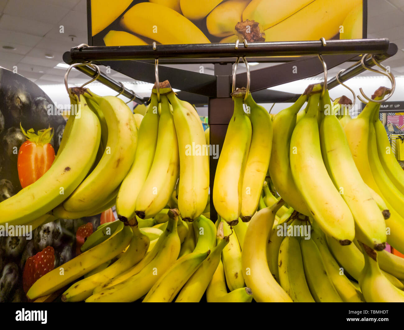Bunches of yellow Banannas for sale inside a shop Stock Photo - Alamy
