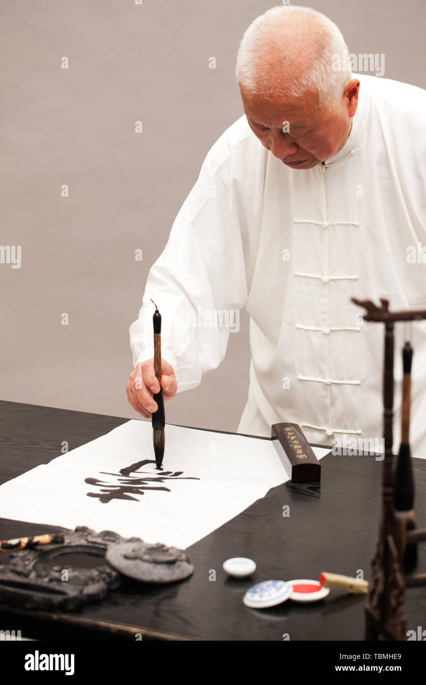An old man practicing calligraphy Stock Photo - Alamy