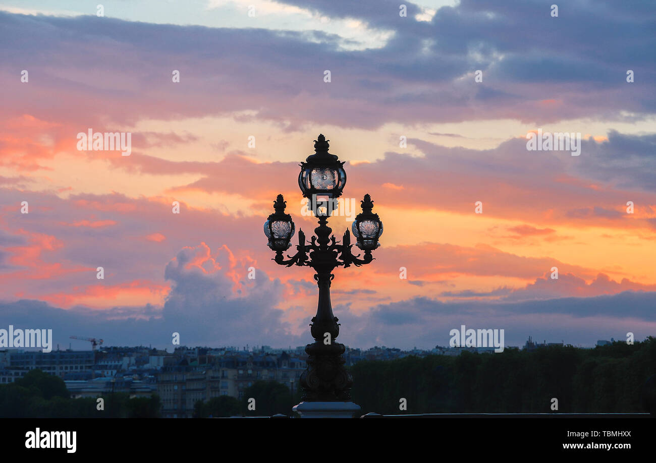 Paris skyline at sunset, with lamp post of Alexandre III bridge, Paris ...