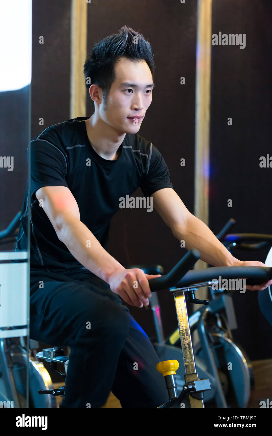young asian man working out in modern gym Stock Photo - Alamy