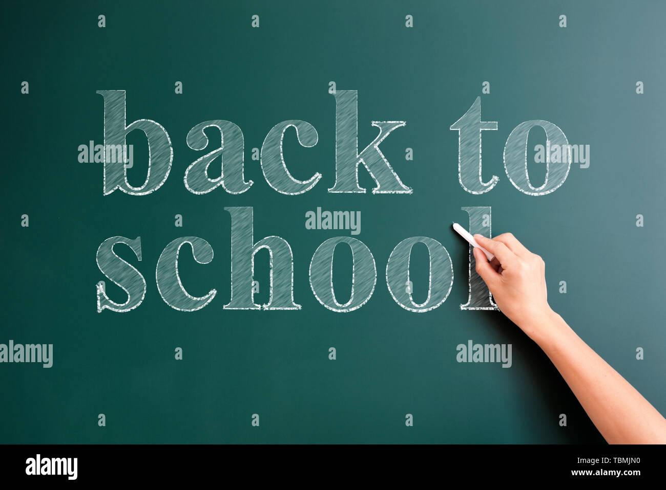 writing back to school on blackboard Stock Photo - Alamy