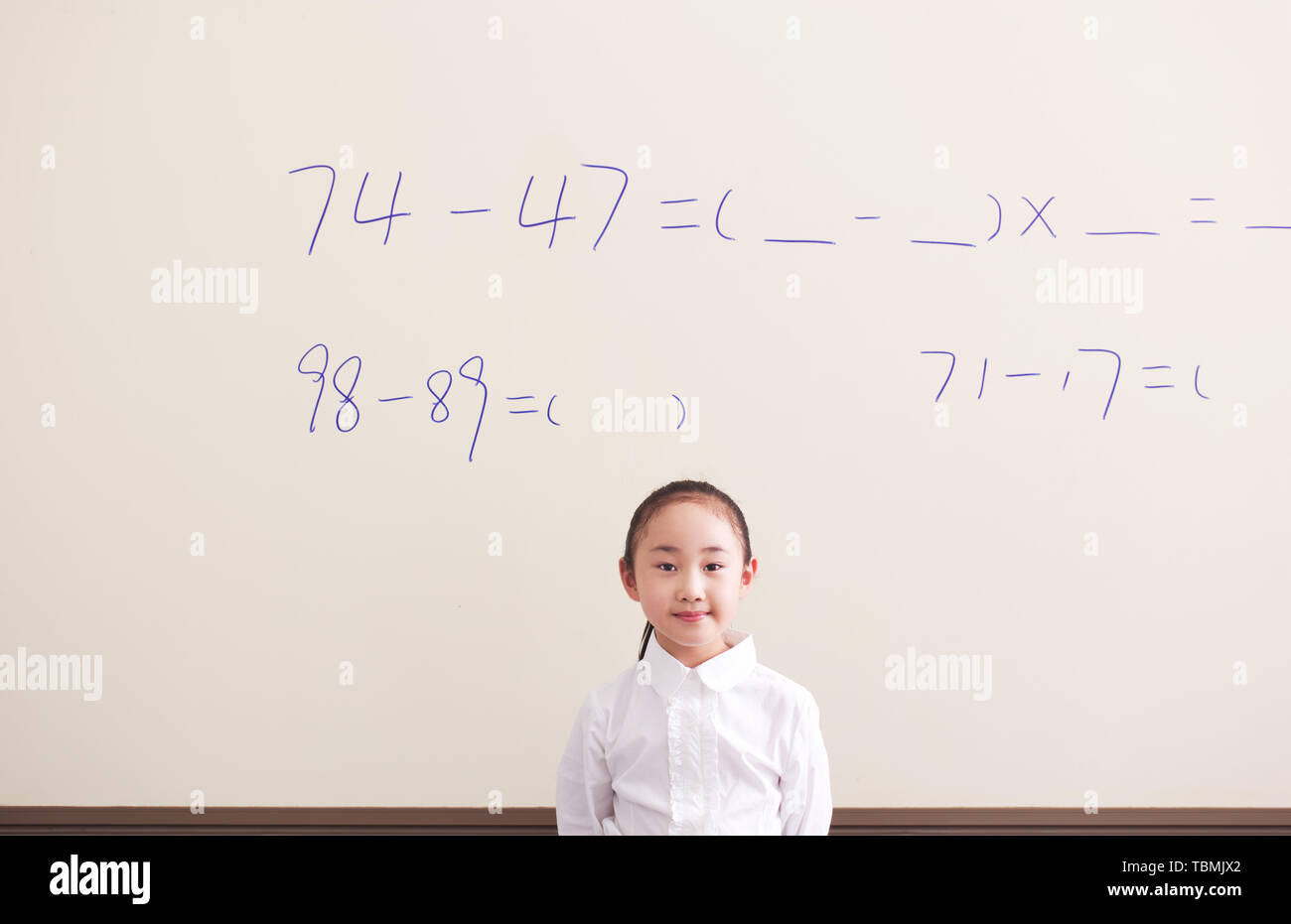 Three primary school students are in class in the classroom Stock Photo ...