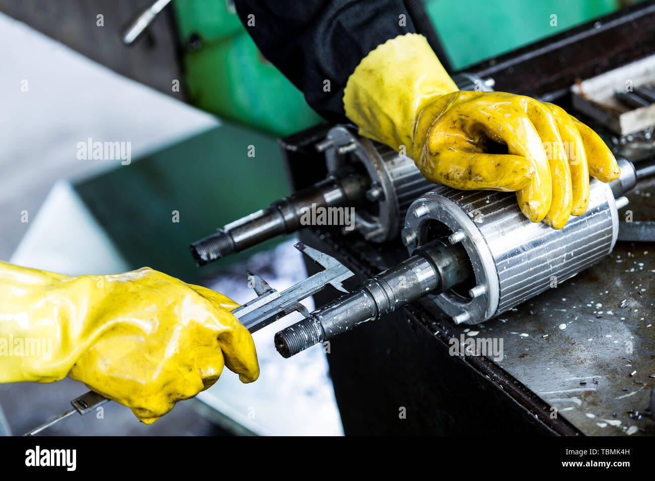worker measure produced spare parts in factory Stock Photo - Alamy
