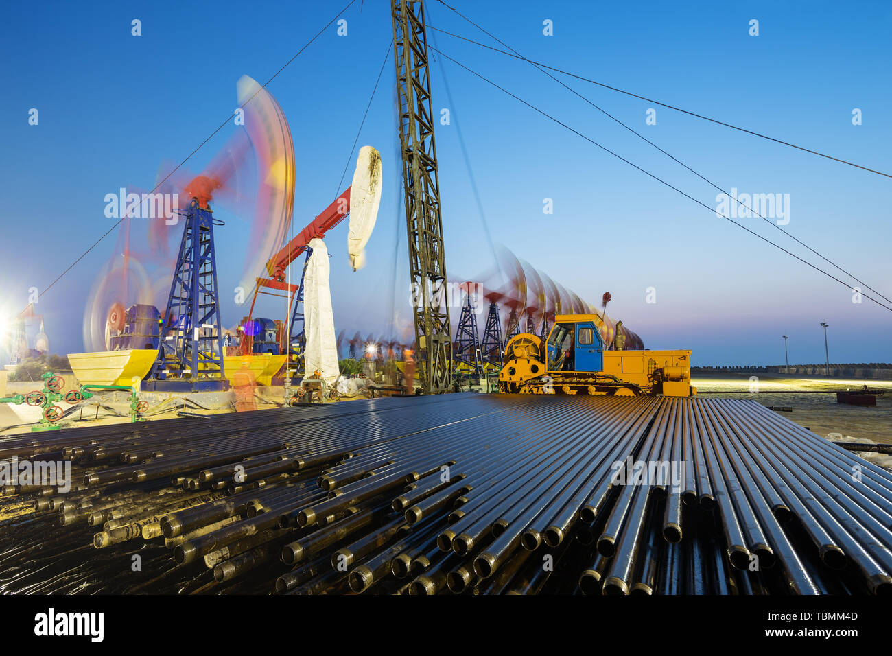 Oil-rig of oilfield day and night Stock Photo - Alamy