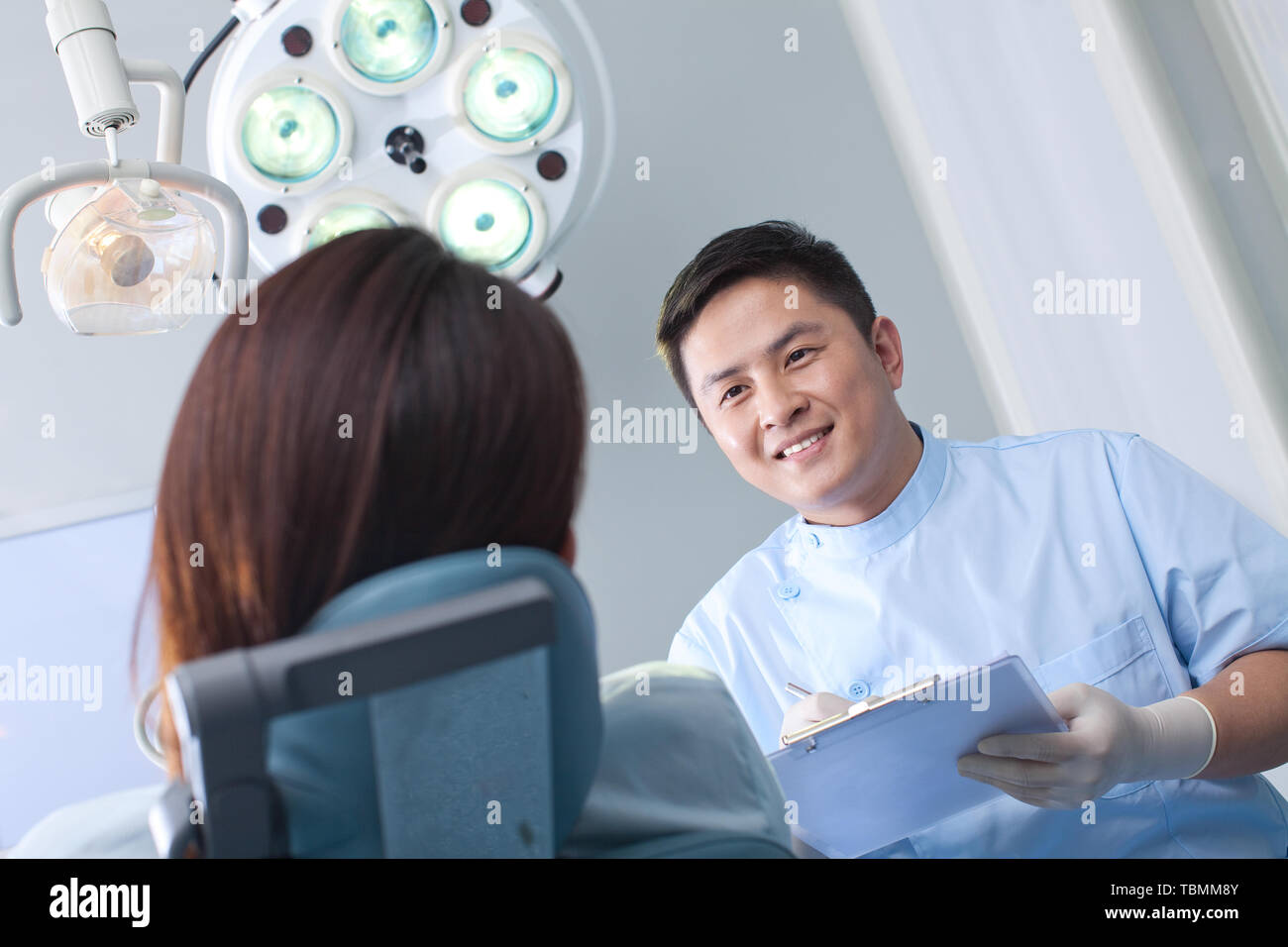 Doctors treat teeth with patients in clinic Stock Photo - Alamy