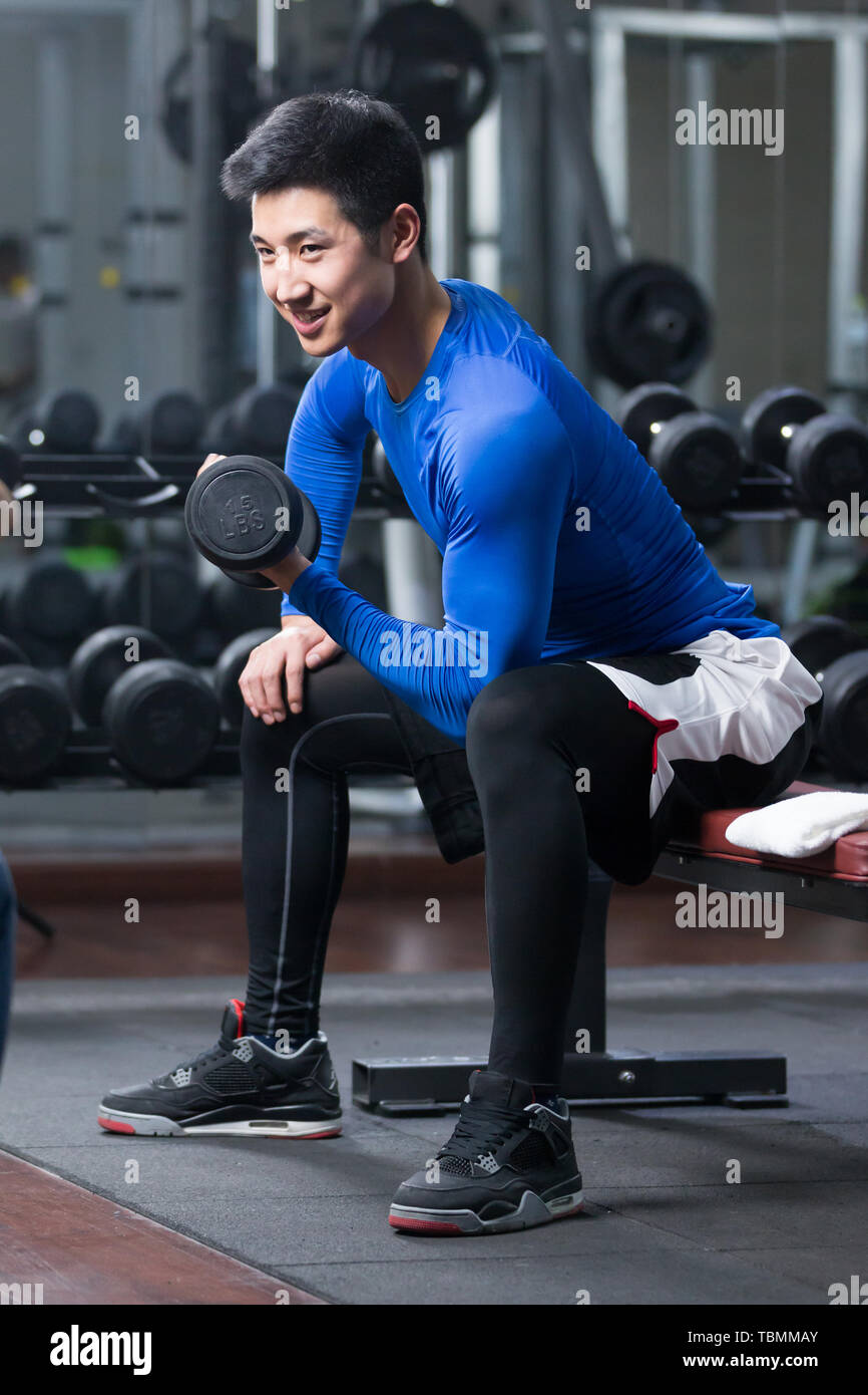 young asian man working out in modern gym Stock Photo - Alamy
