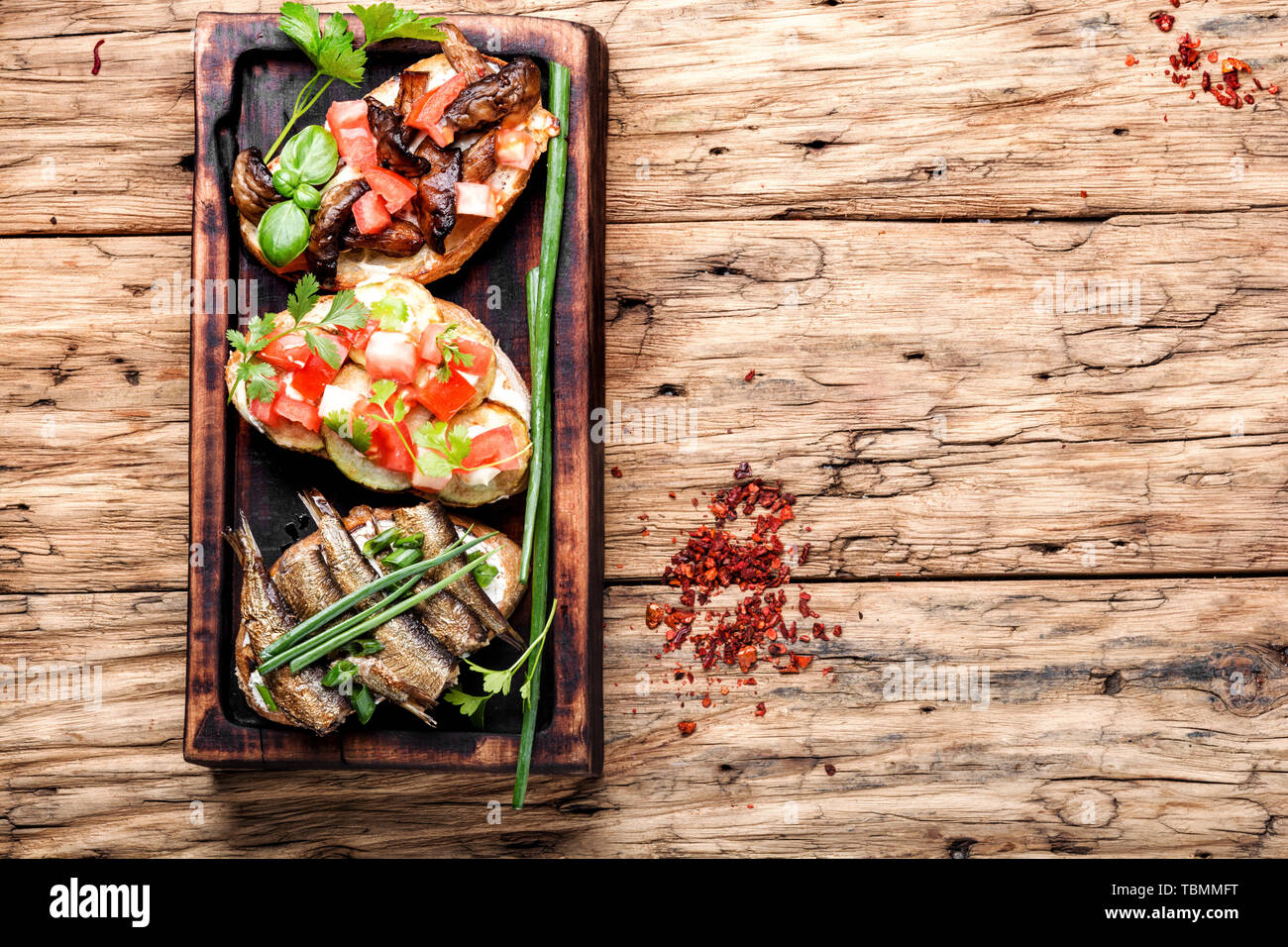 Variety of small sandwiches.Bruschetta on wooden cutting board ...