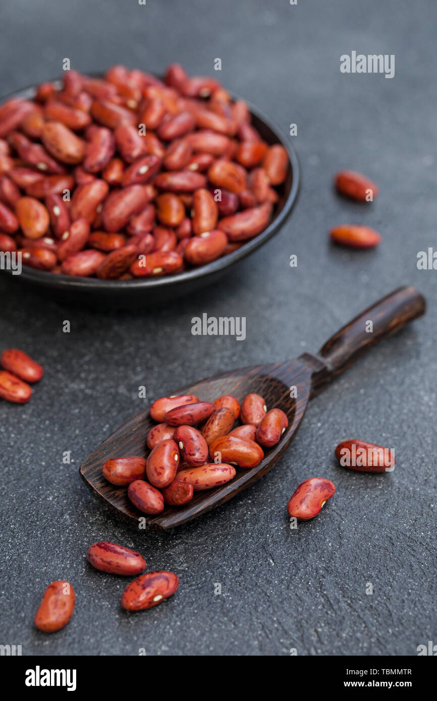 Red kidney beans in a black bowl on grey stone background Stock Photo ...