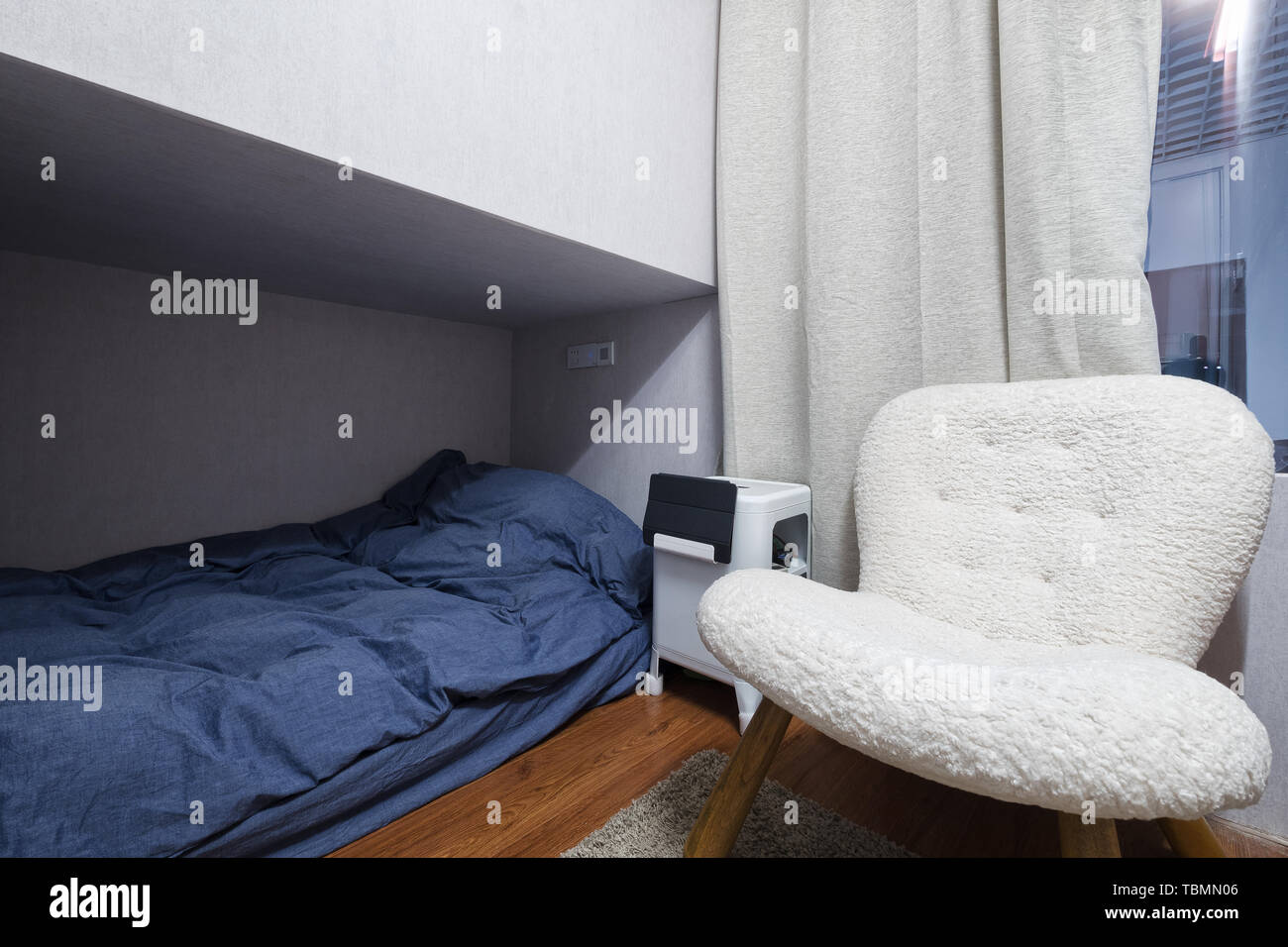 Simple bed with soft quilt Stock Photo - Alamy