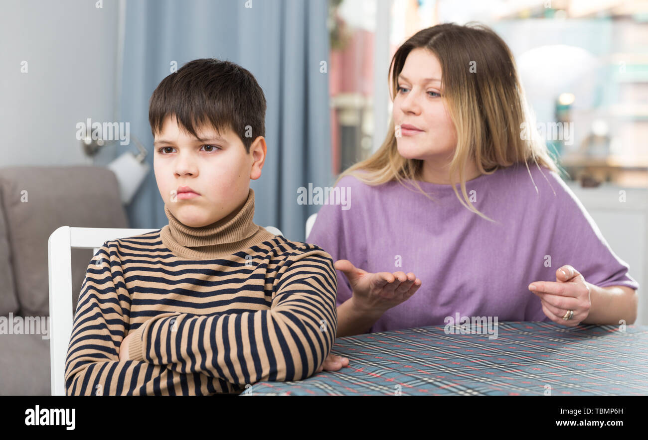 Upset mother and offended son arguing in domestic interior Stock Photo ...