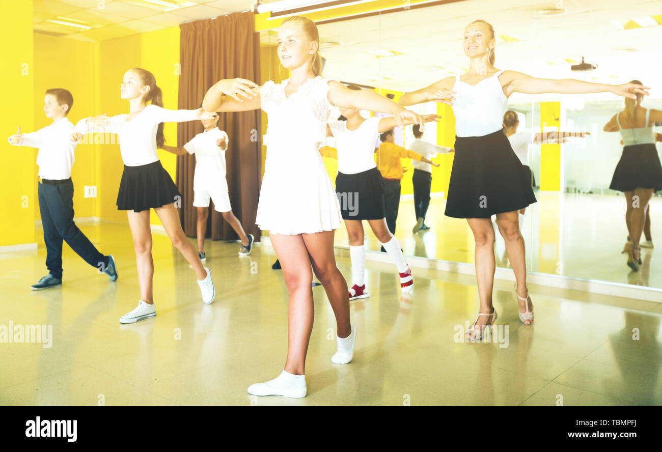 Smiling children learn dance movements in dance class Stock Photo - Alamy