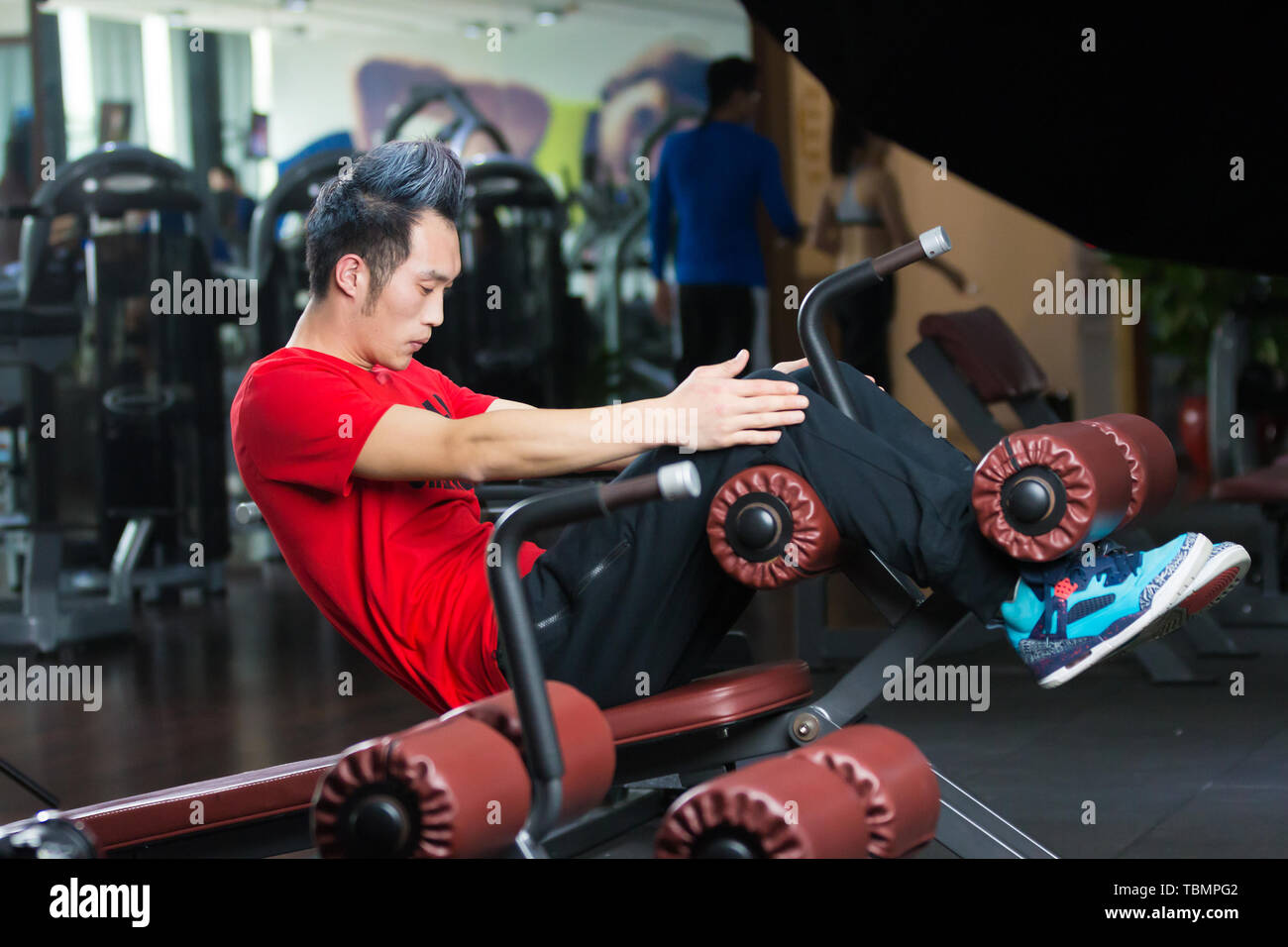 young asian man working out in modern gym Stock Photo - Alamy